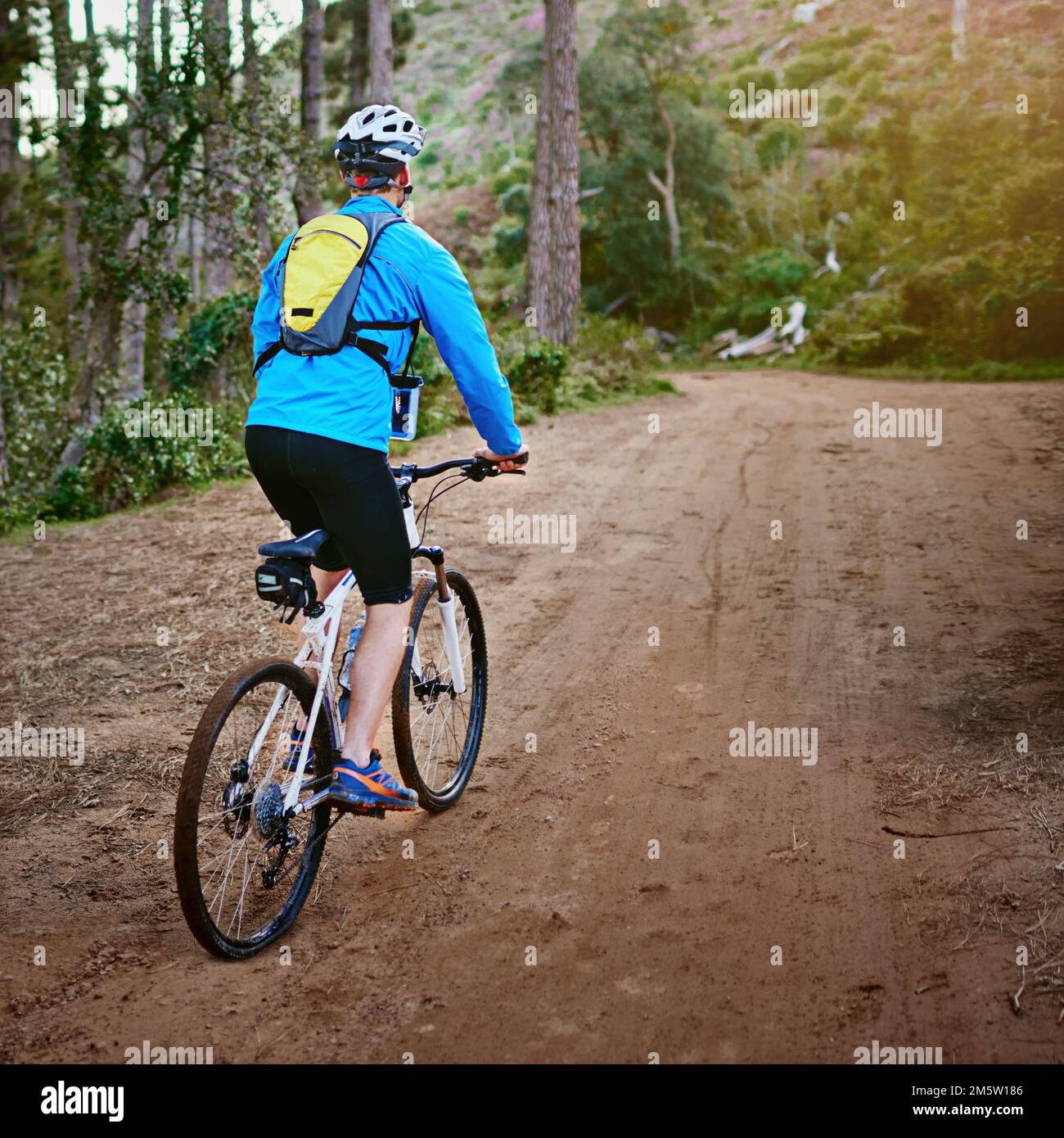 Setting out on an adventure. a male cyclist riding along a mountain ...