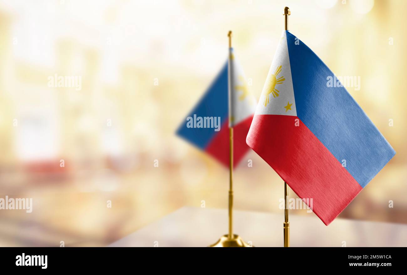 Small flags of the Philippines on an abstract blurry background Stock ...