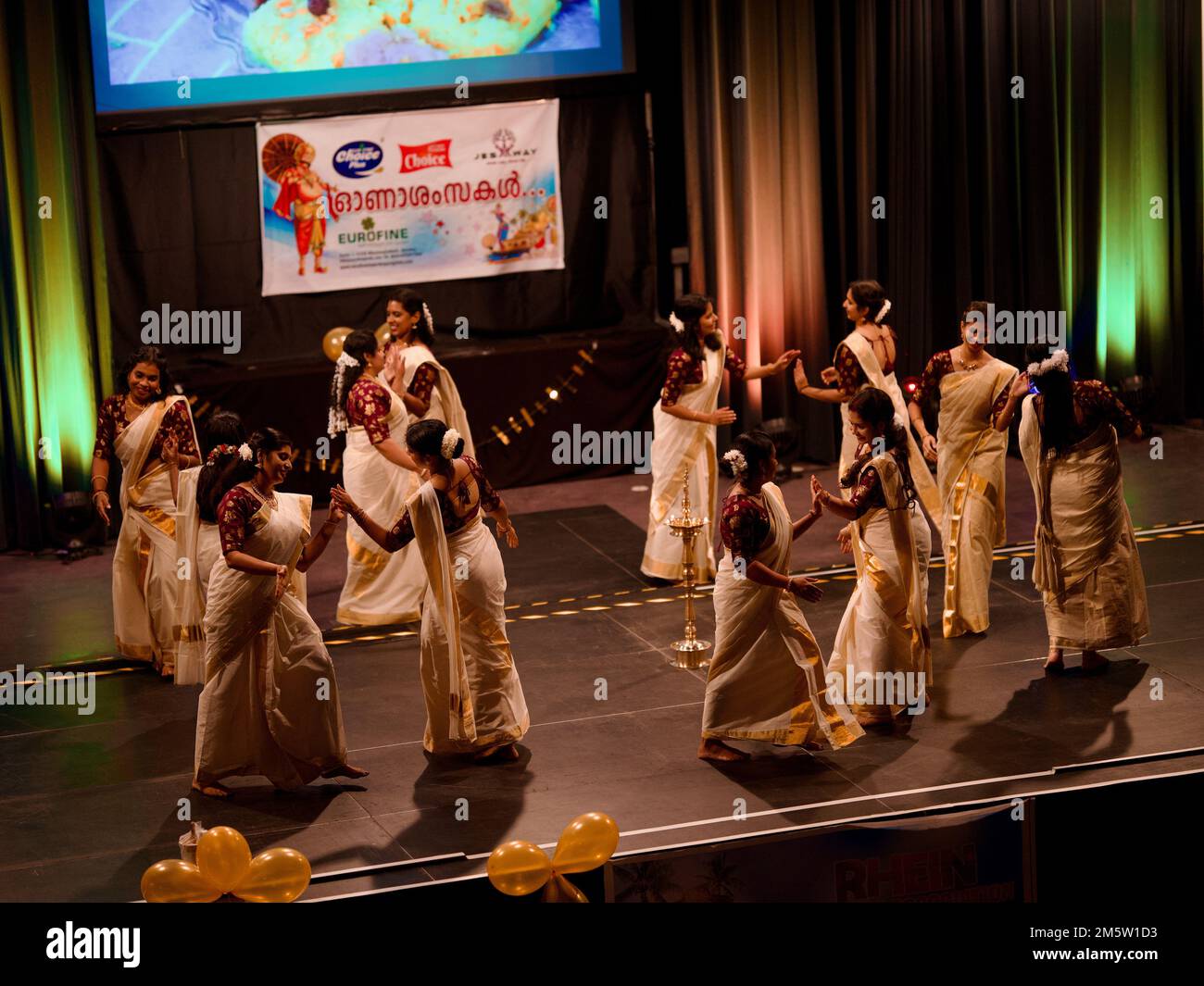 Beautiful Indian girls in traditional dresses performing a welcome ...