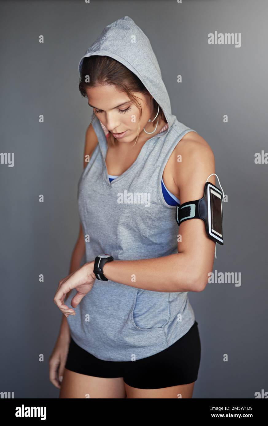 Beat your best. a sporty young woman checking the time on her sports ...