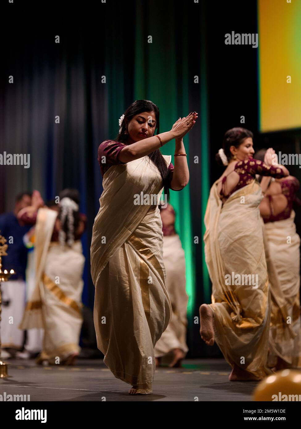 Beautiful Indian girls in traditional dresses performing a welcome ...