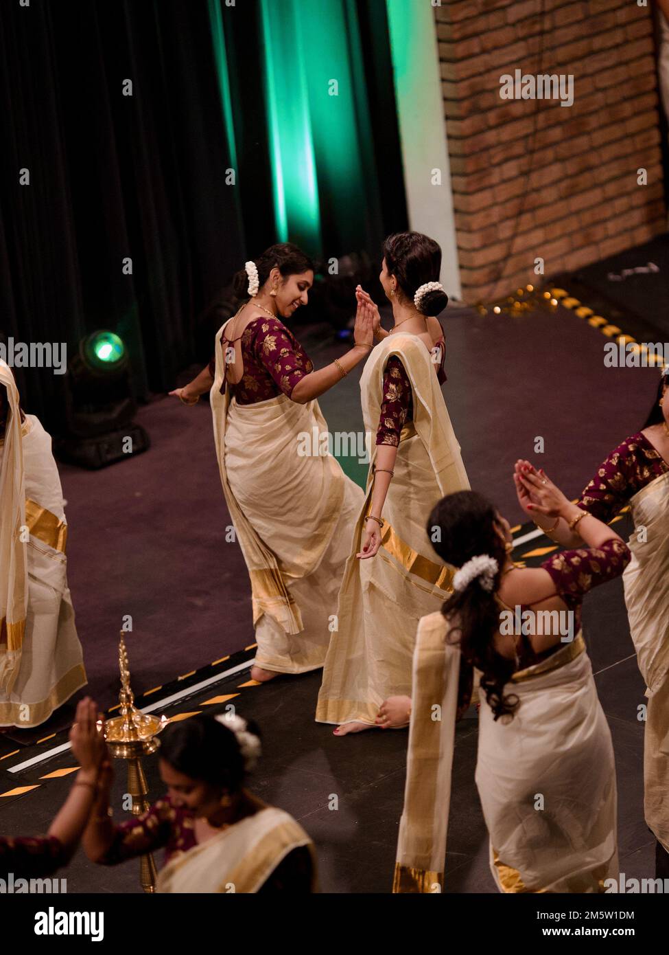 Beautiful Indian girls in traditional dresses performing a welcome ...