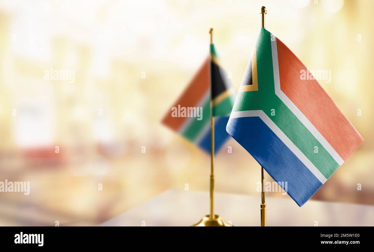 Small flags of the South Africa on an abstract blurry background Stock ...