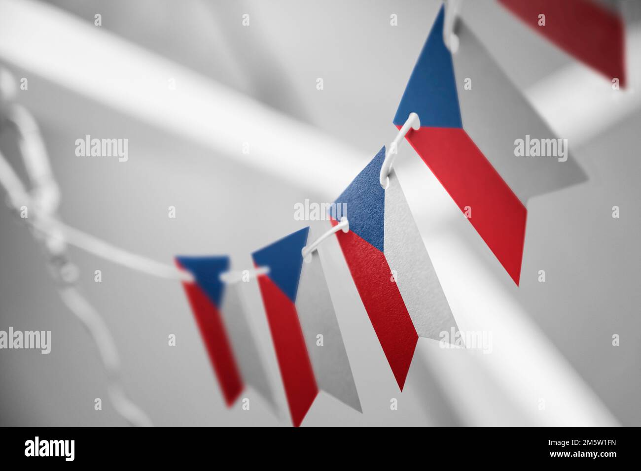 A garland of Czechia national flags on an abstract blurred background ...