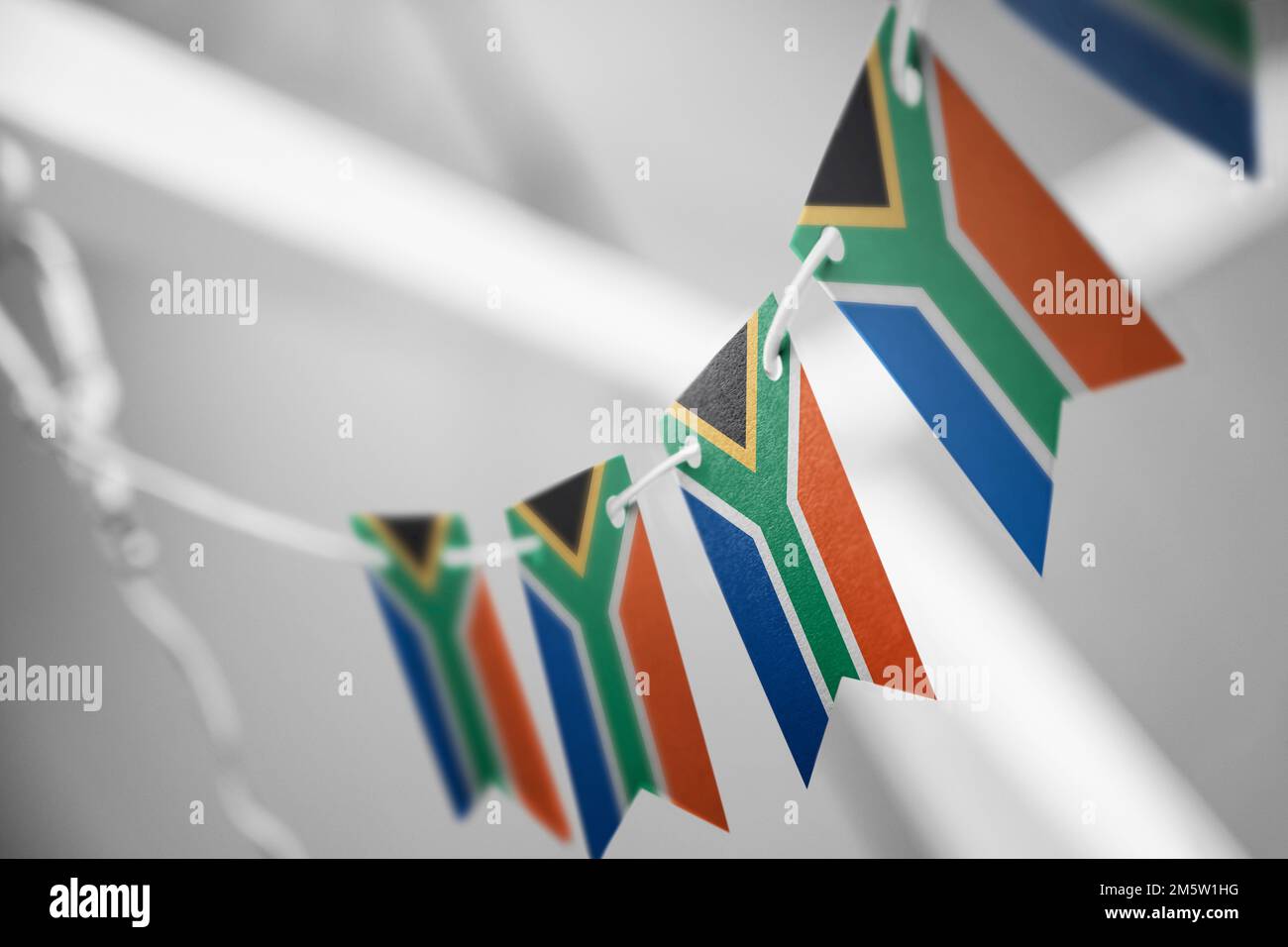 A garland of South Africa national flags on an abstract blurred ...