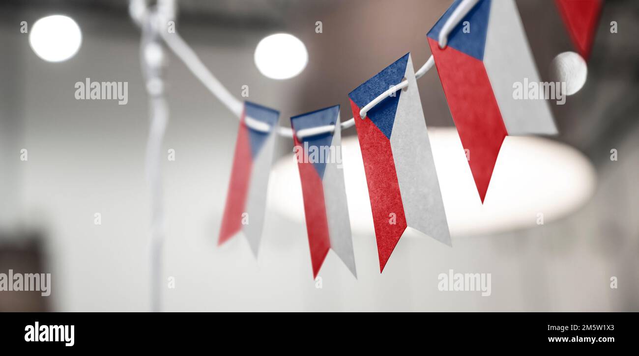 A garland of Czechia national flags on an abstract blurred background ...