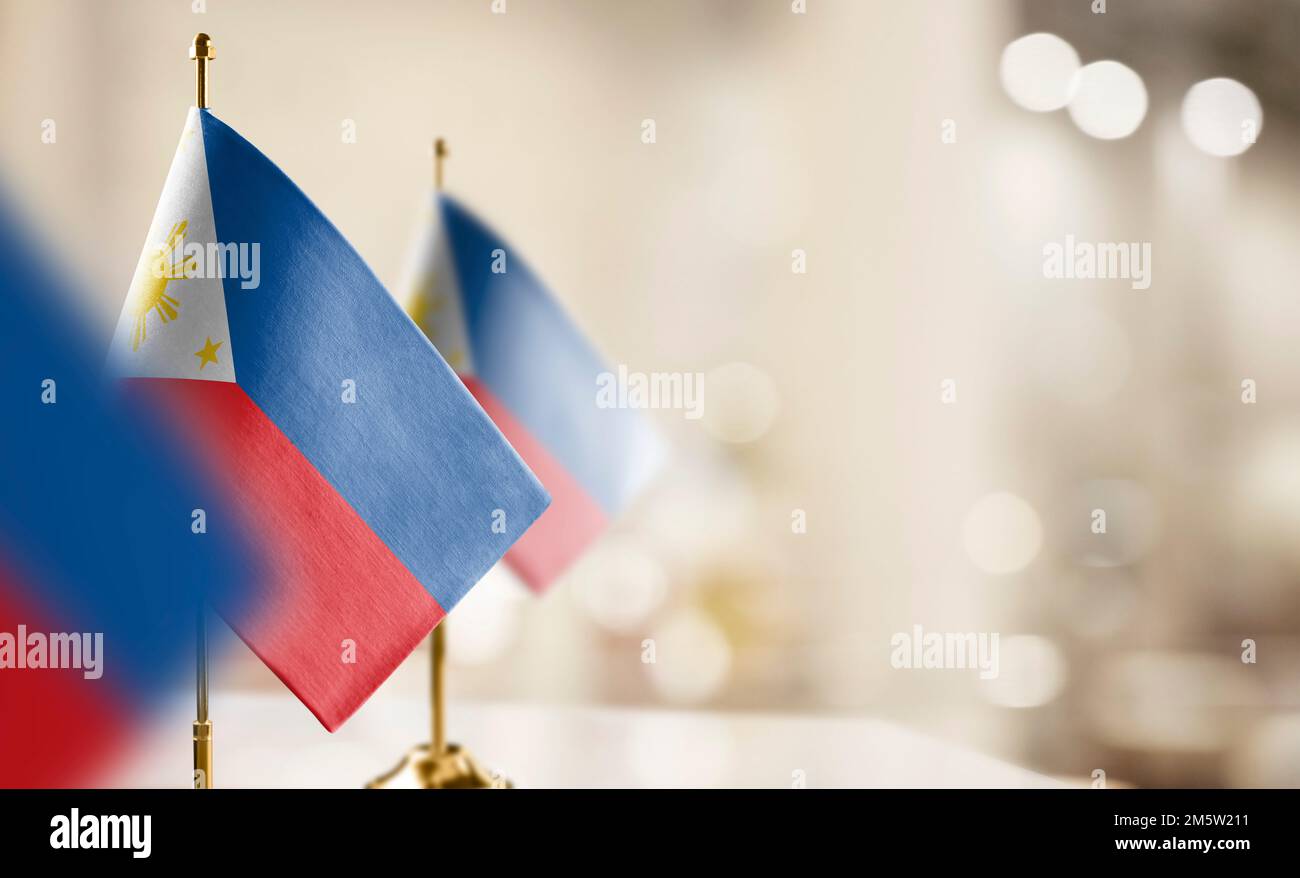 Small flags of the Philippines on an abstract blurry background Stock ...