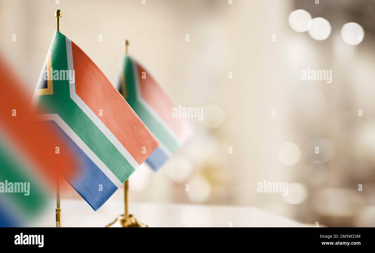 Small flags of the South Africa on an abstract blurry background Stock ...