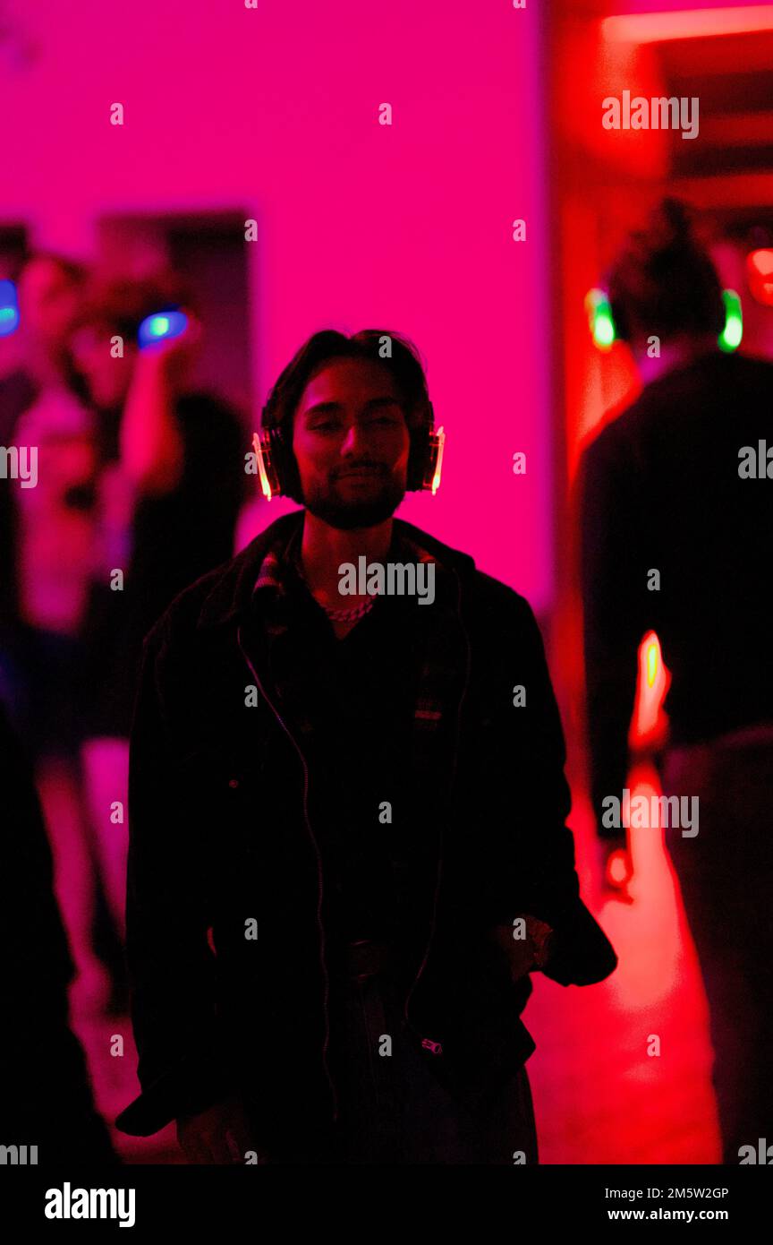 A young happy boy in headphones having fun at a party in Kamp Lintfort ...