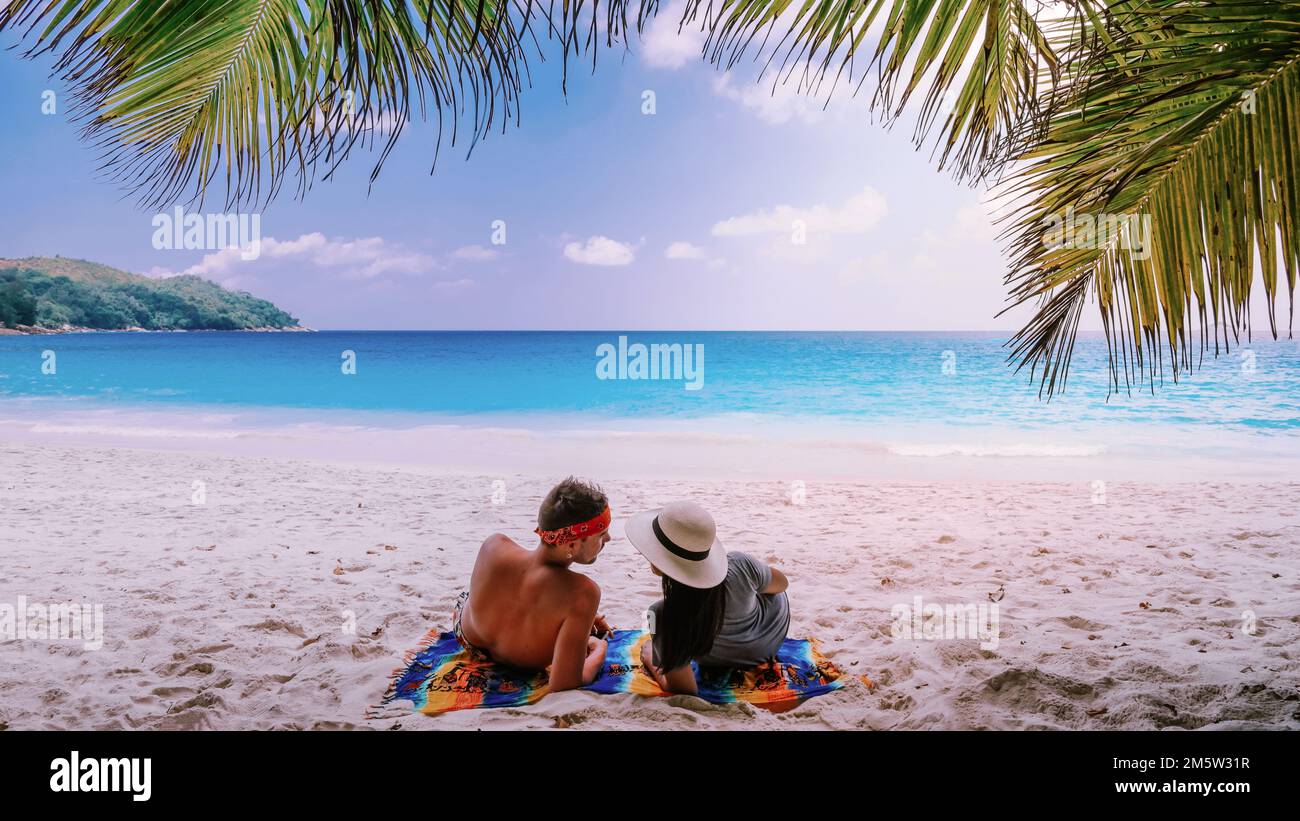 Tropical white beach at Praslin island Seychelles, happy Young couple ...