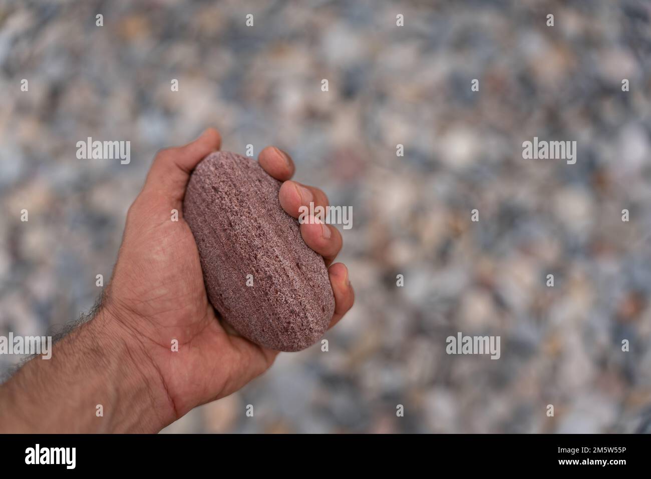 Hand holding stone beach hi-res stock photography and images - Alamy