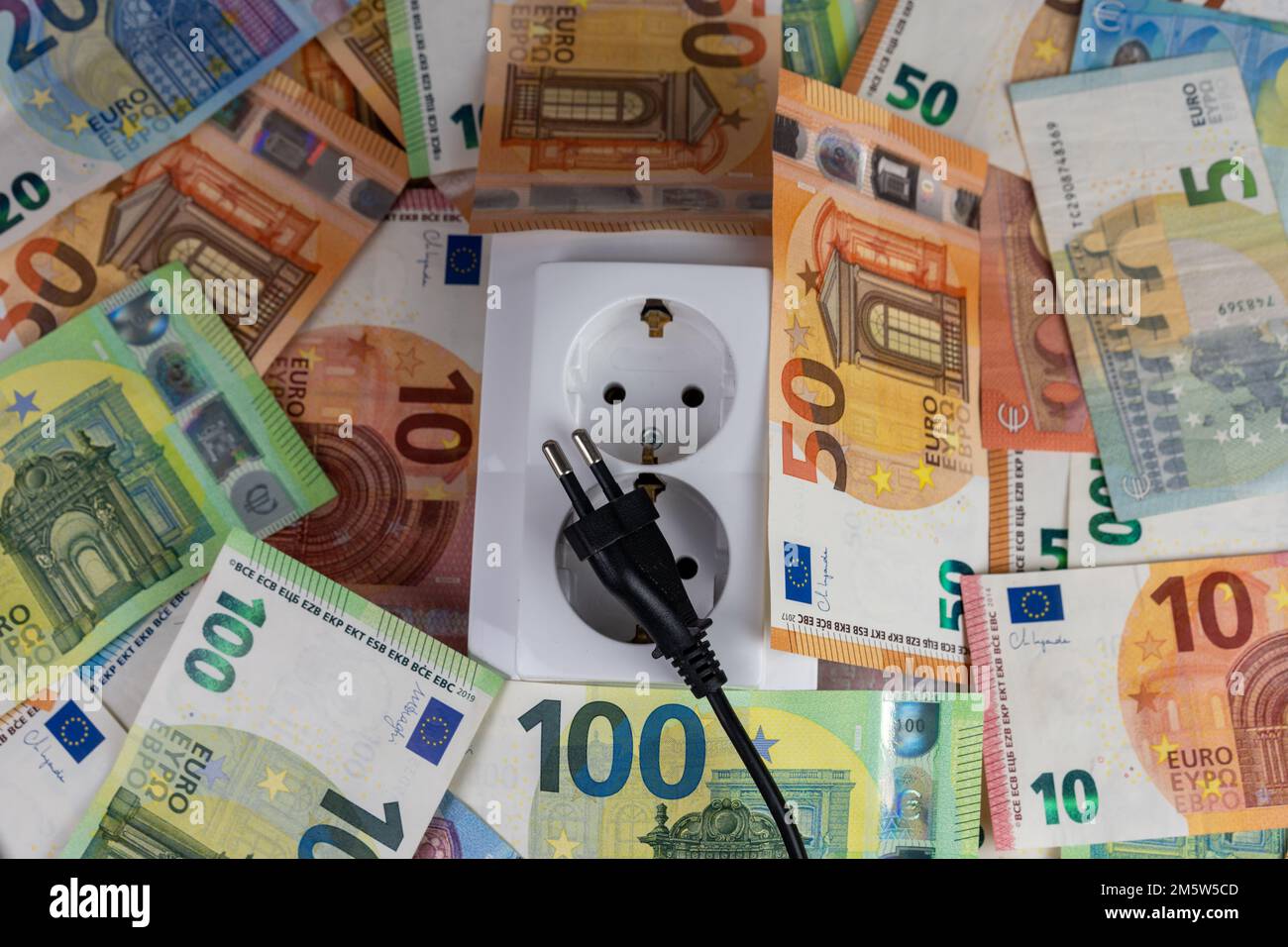 An electrical outlet among many 50, 20, 5, and 100 euro banknotes Stock ...