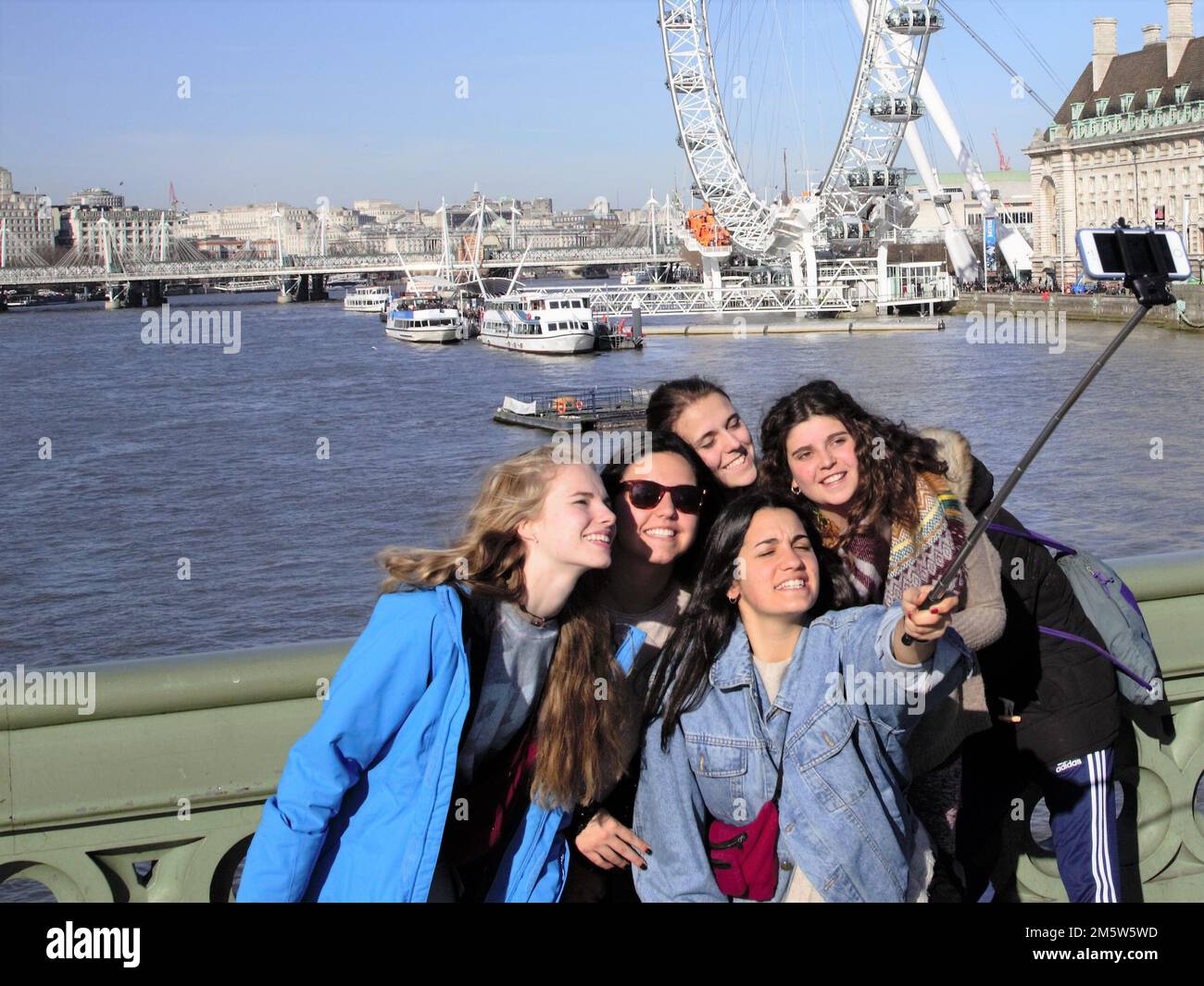 Five women taking selfies on Westminster Bridge, London, UK Stock Photo - Alamy