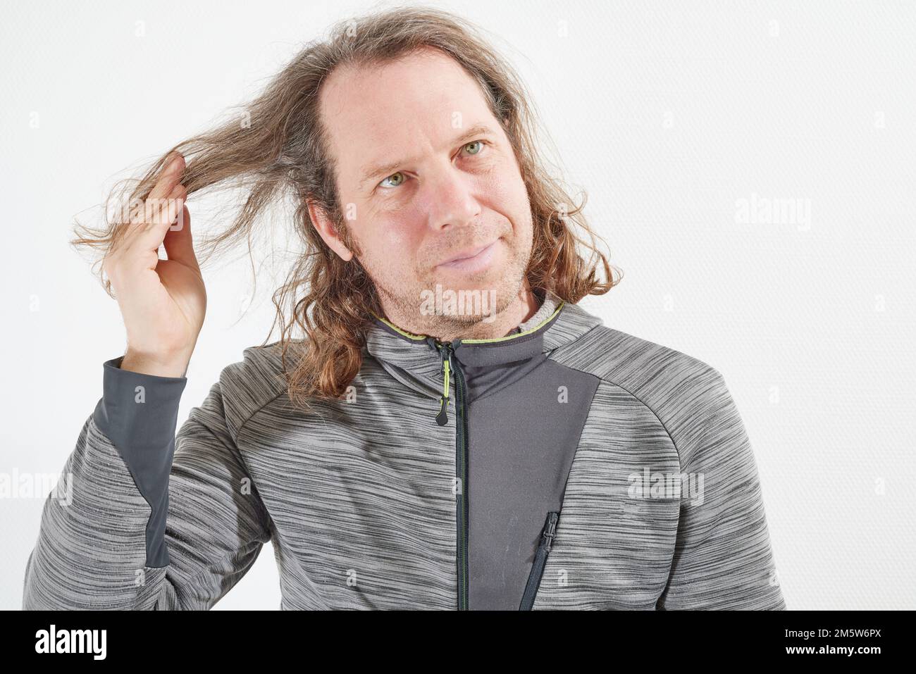 Man with hand on his long hair Stock Photo - Alamy