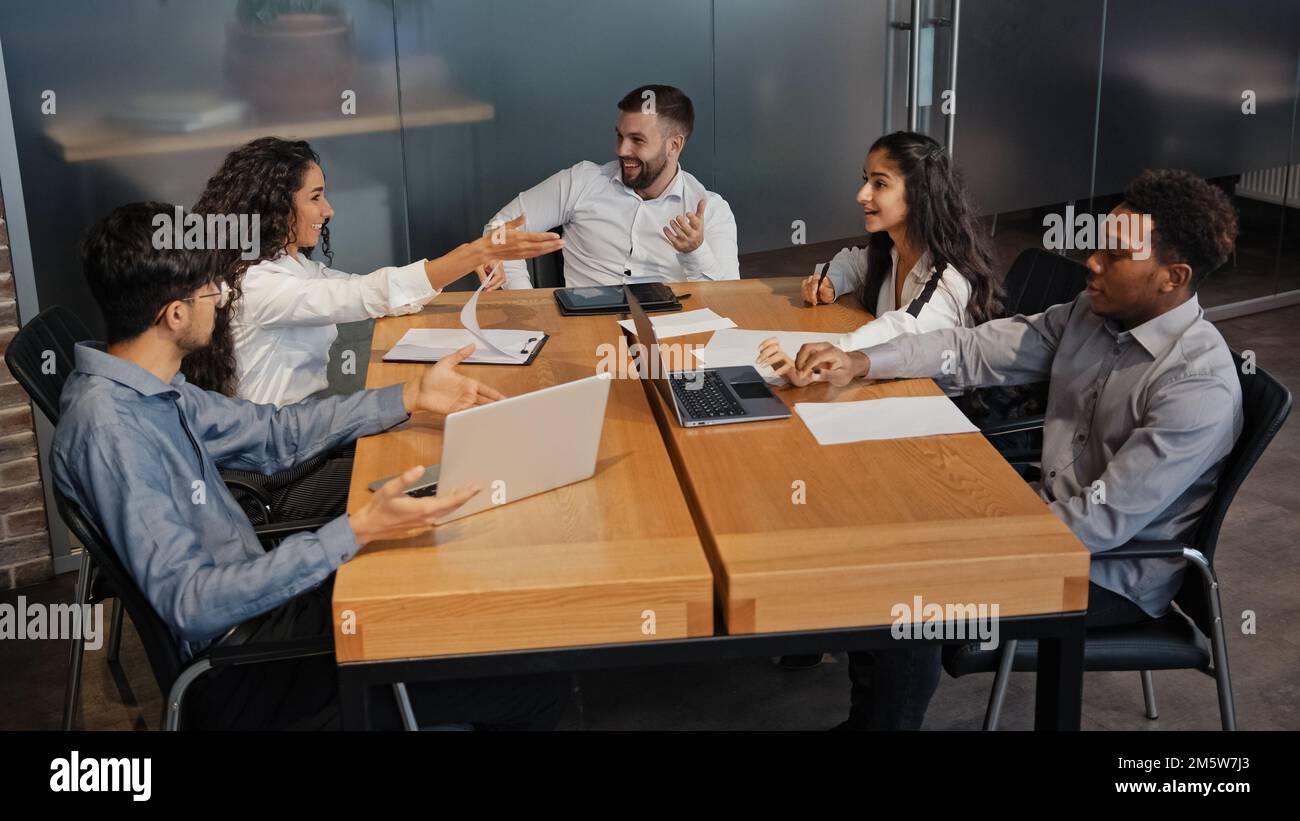 Successful multiethnic colleagues discussing idea project in office ...