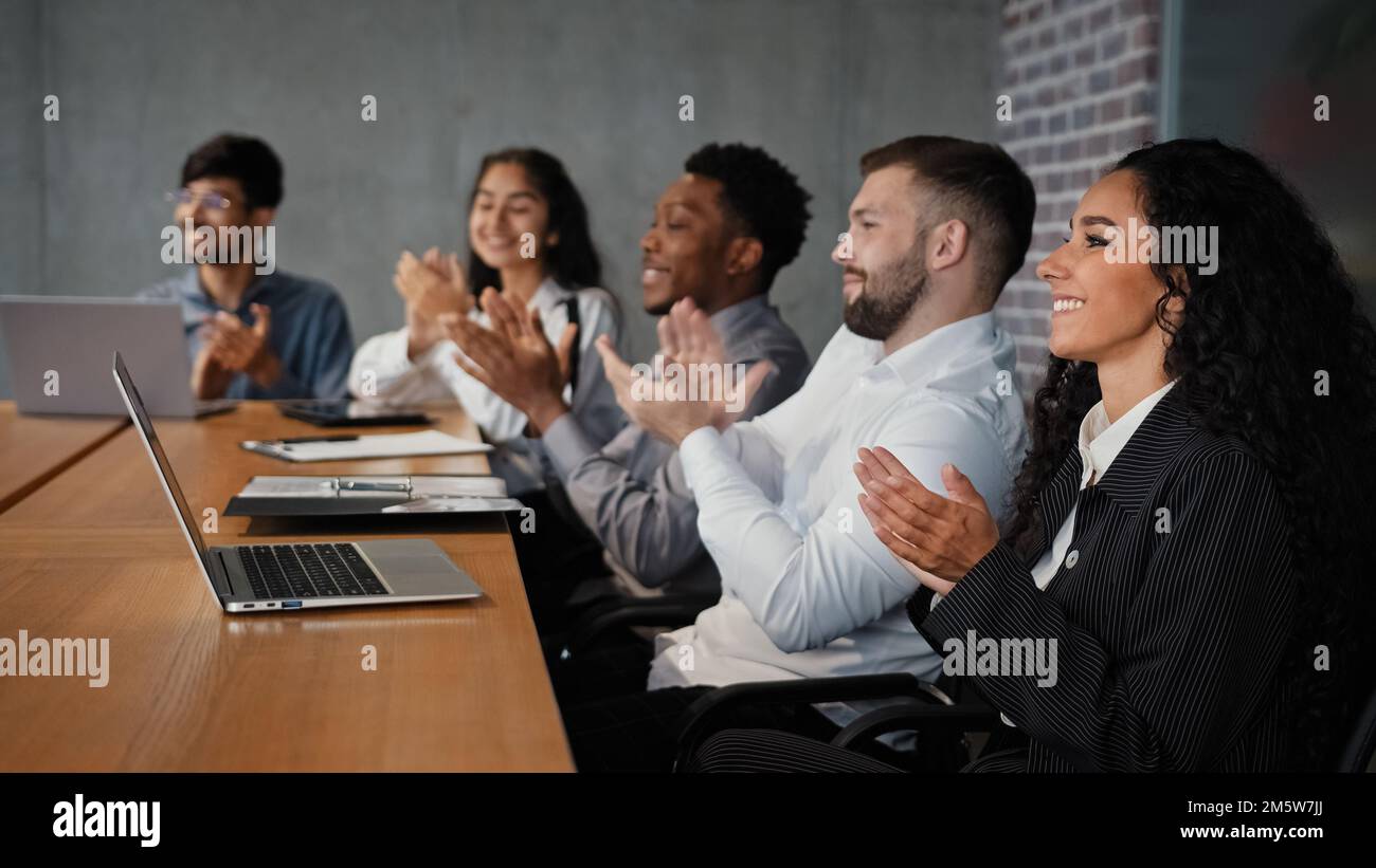 Satisfied multiracial business team partners colleagues workers employees in conference listen ...