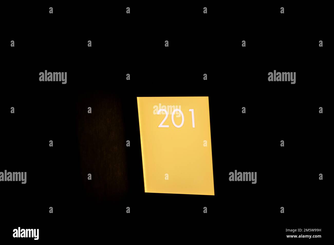 Colourful three digit numbers set against black background in London ...