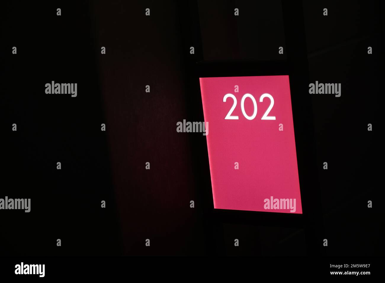 Colourful three digit numbers set against black background in London ...