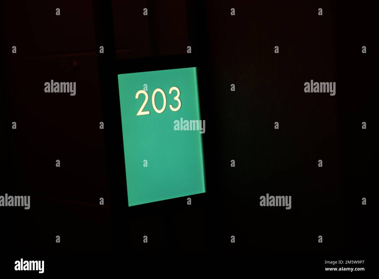 Colourful three digit numbers set against black background in London ...