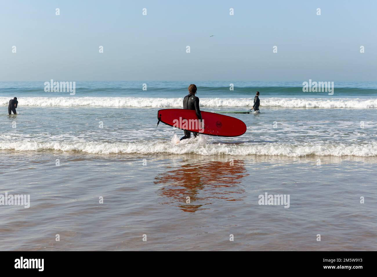 People surfing in Atlantic Ocean on beach, Taghazout, Morocco, North ...