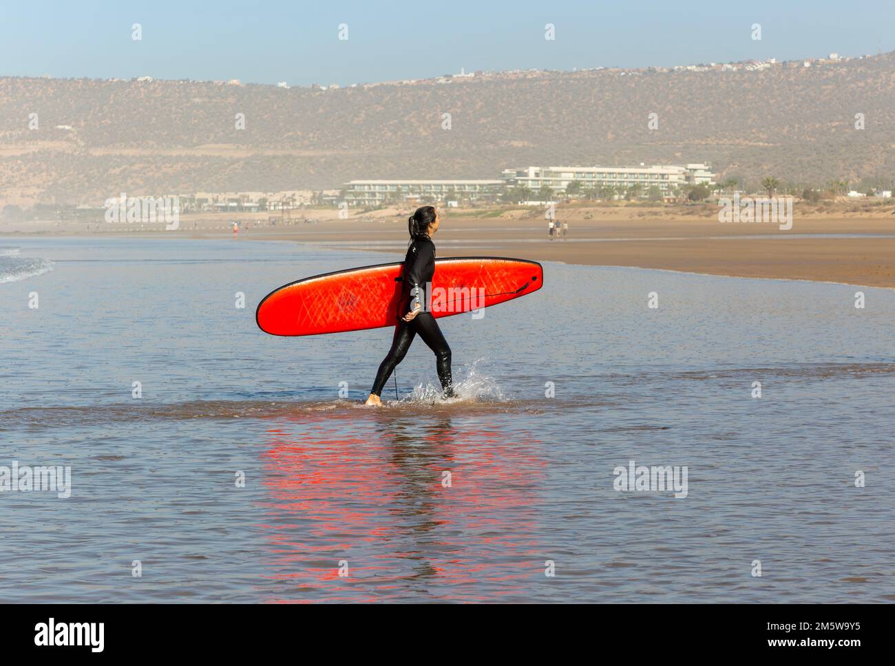 Person surfer in Atlantic Ocean on beach, Taghazout, Morocco, North ...