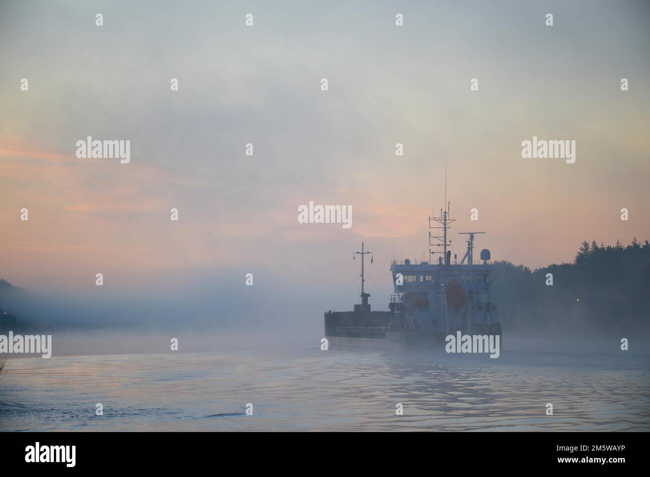 Cargo ship in fog in the Kiel Canal, Germany Stock Photo - Alamy