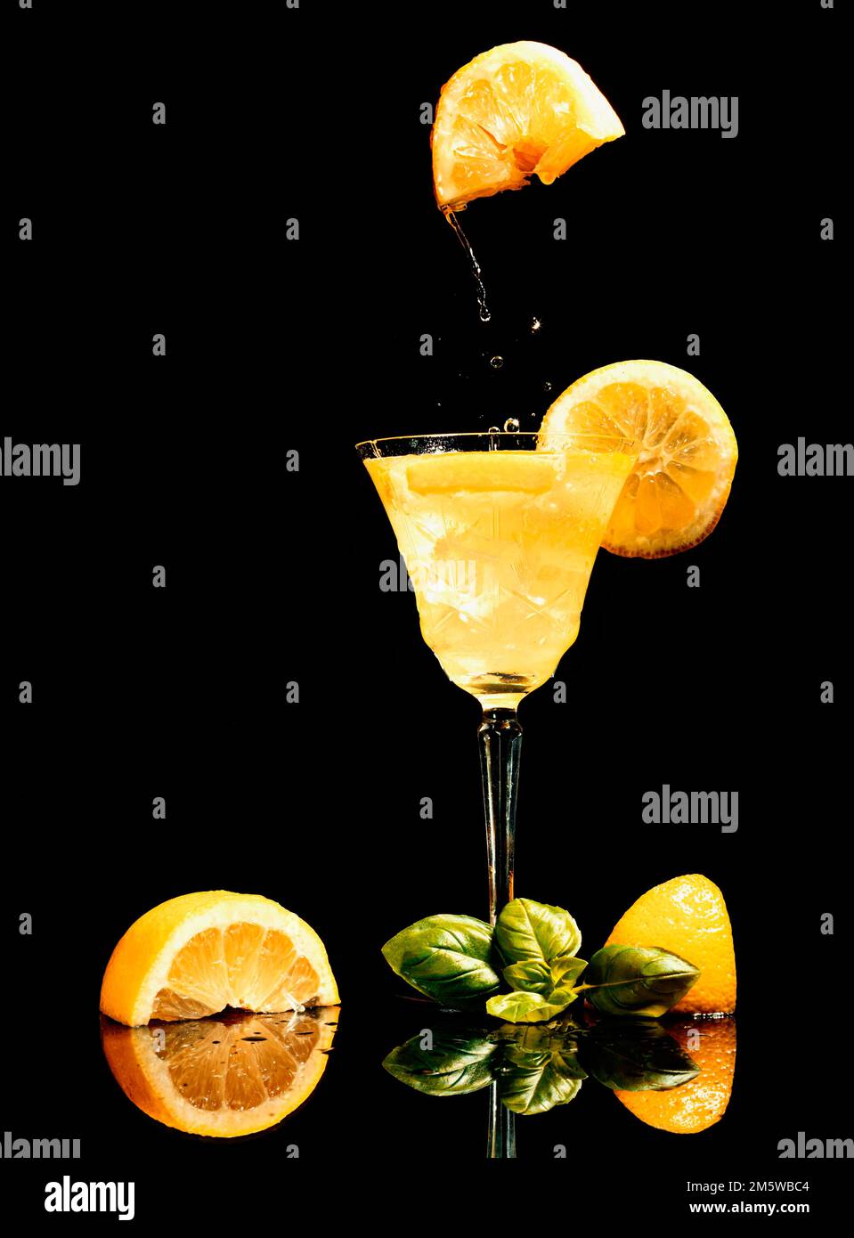 Food photography, lemon floating over glass with lemon juice, cocktail ...