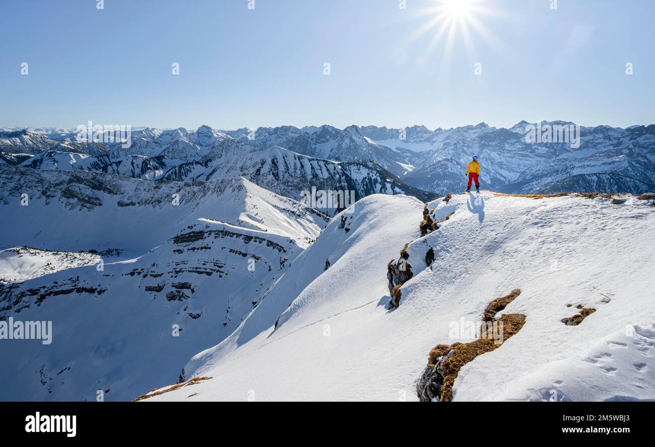 Ski tourers at the summit of Schafreuter, view of snowy mountain ...