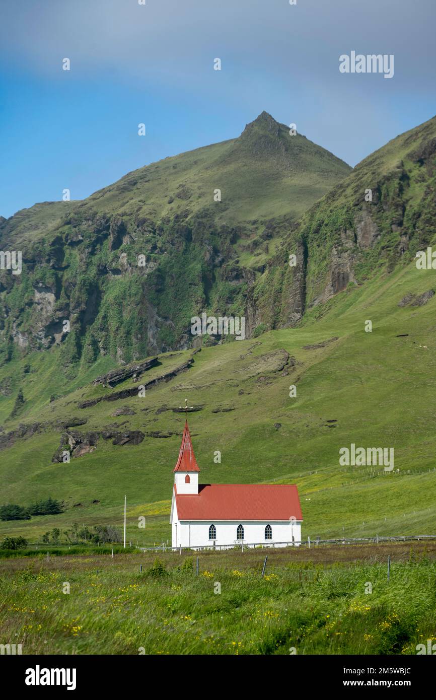 Vik Church, Vikurkirkja, between green mountains, Vik, South Iceland ...