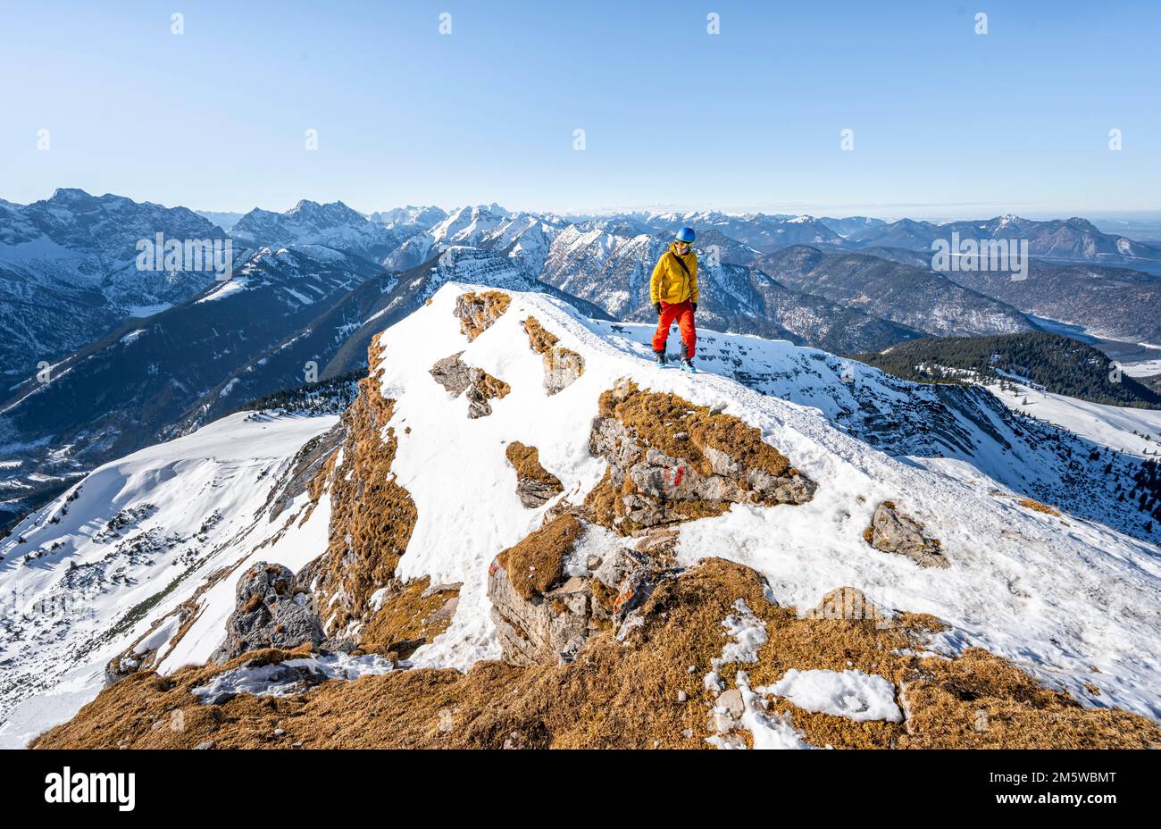 Ski tourers at the summit of Schafreuter, view of snow-covered mountain ...