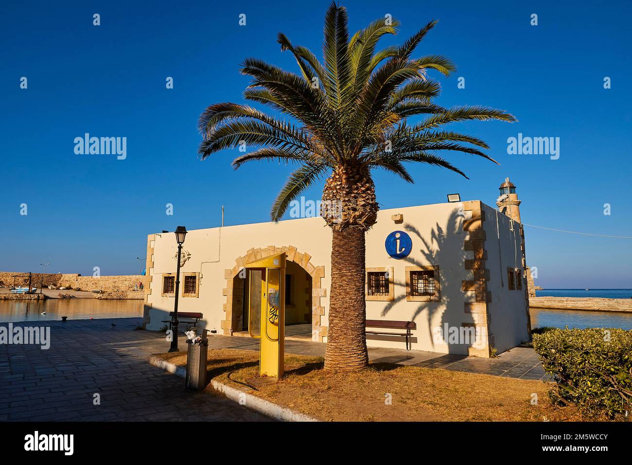 Tourist information building, palm tree, lantern, cloudless blue sky ...