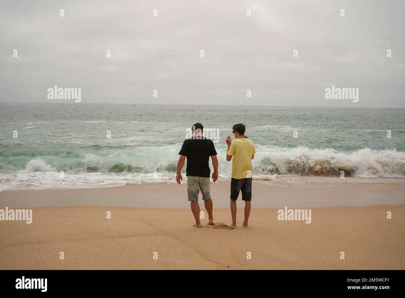 Two people having fun at the beach Stock Photo - Alamy