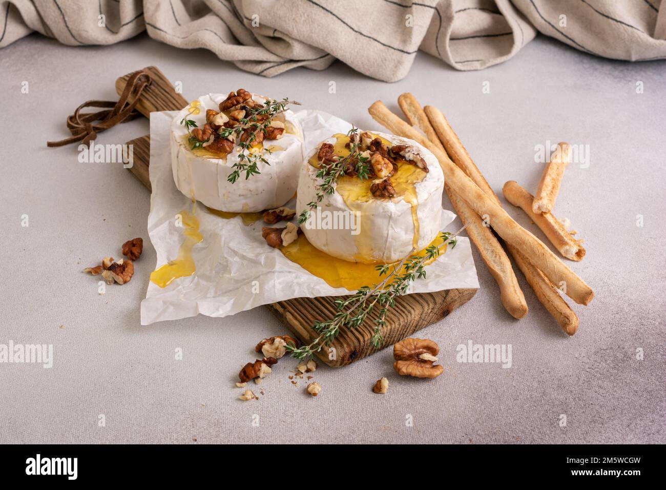 Gourmet meal of white brie cheese or camembert with thyme, walnut ...