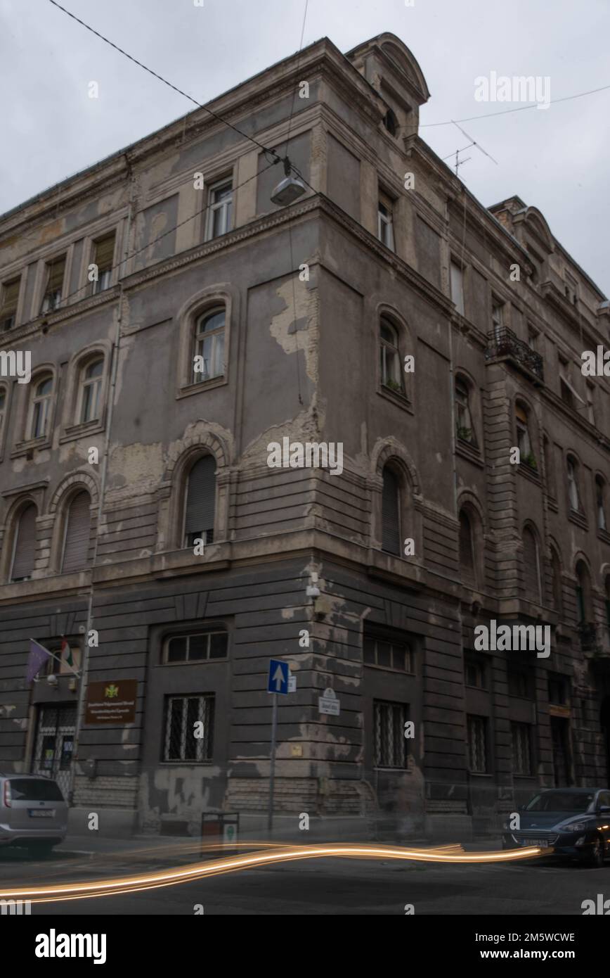 Fast car passing an old grey building Stock Photo - Alamy