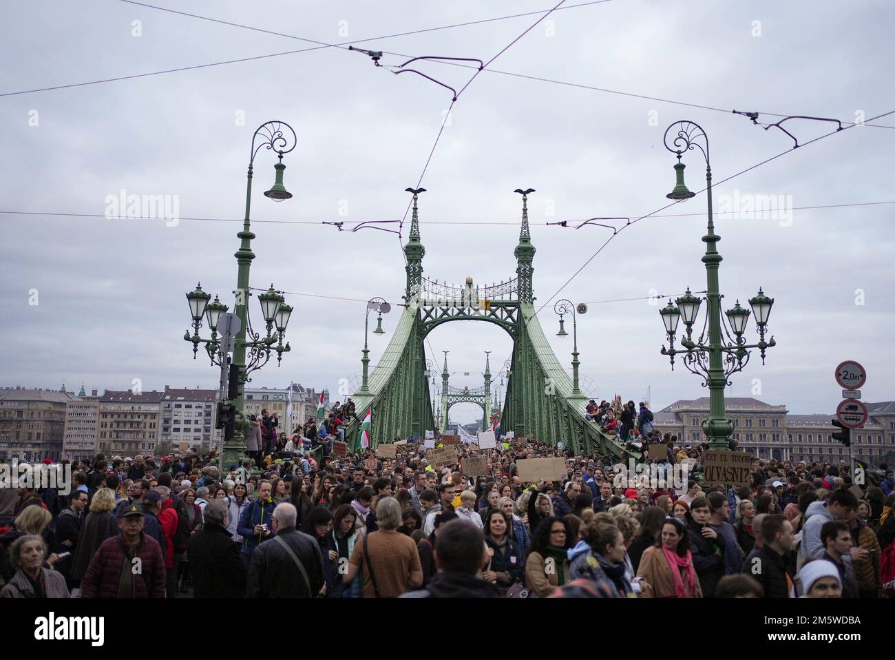 Protesting people marching down a bridge Stock Photo - Alamy