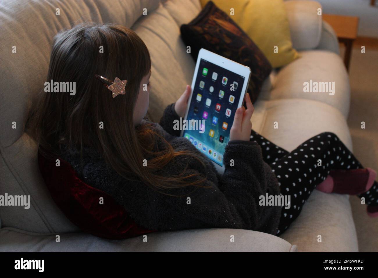 Girl with ipad tablet computer sitting inside Stock Photo - Alamy