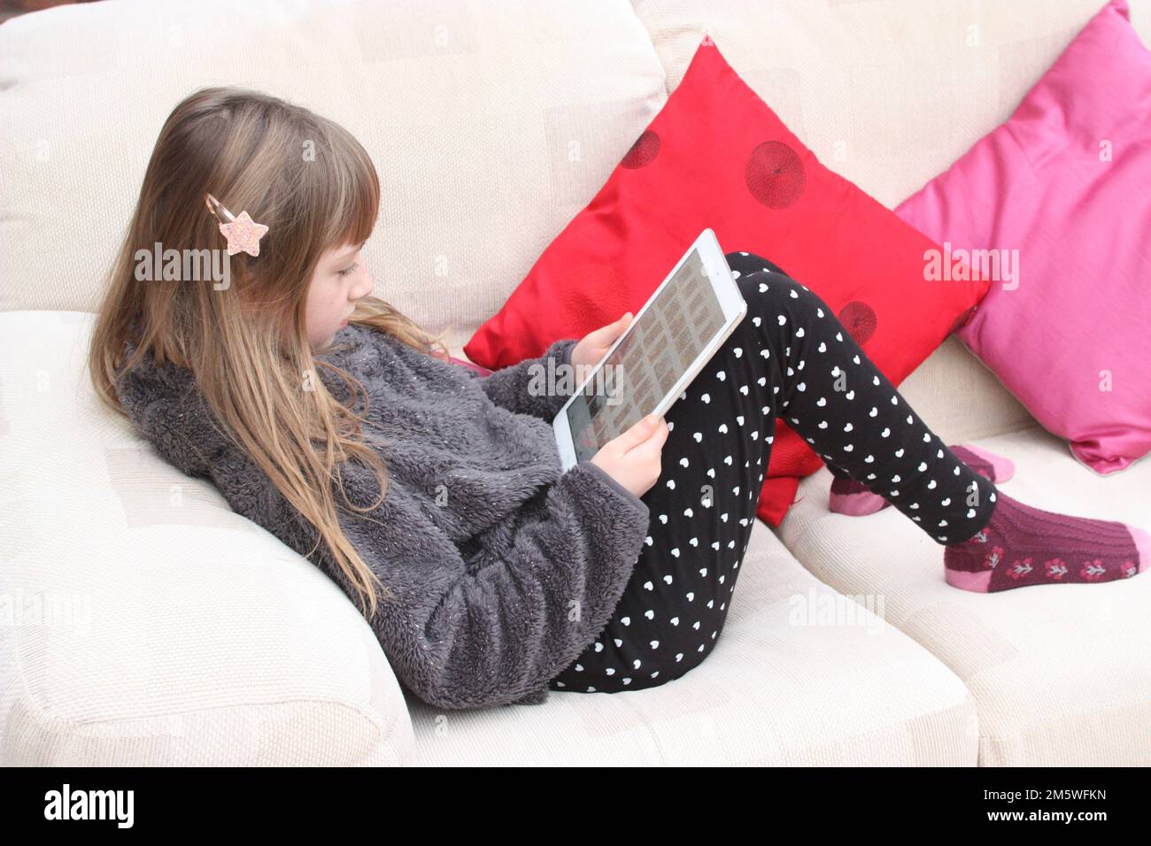 Girl with ipad tablet computer sitting inside Stock Photo - Alamy