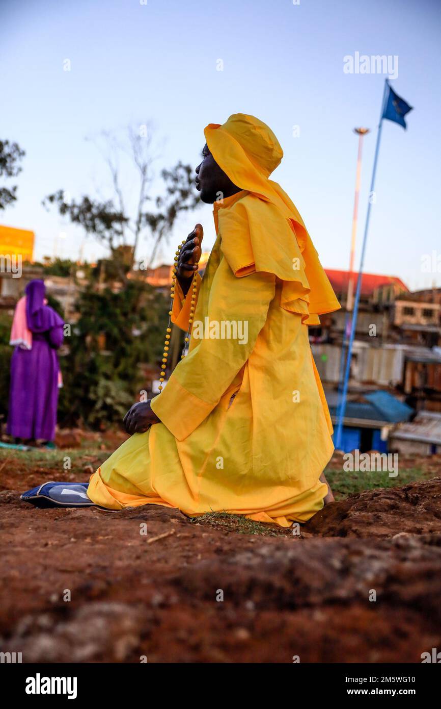 Steven Ouma praying at a Legion Maria worship ground in Kibera Slum of ...