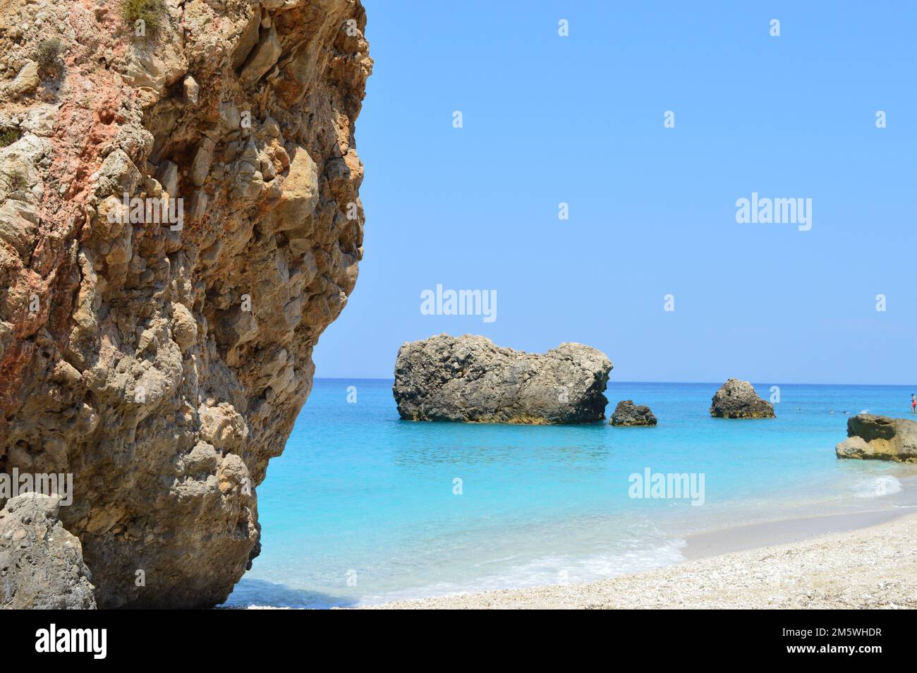 An image of big rocks in the Megali Petra beach in Lefkada, Greece ...
