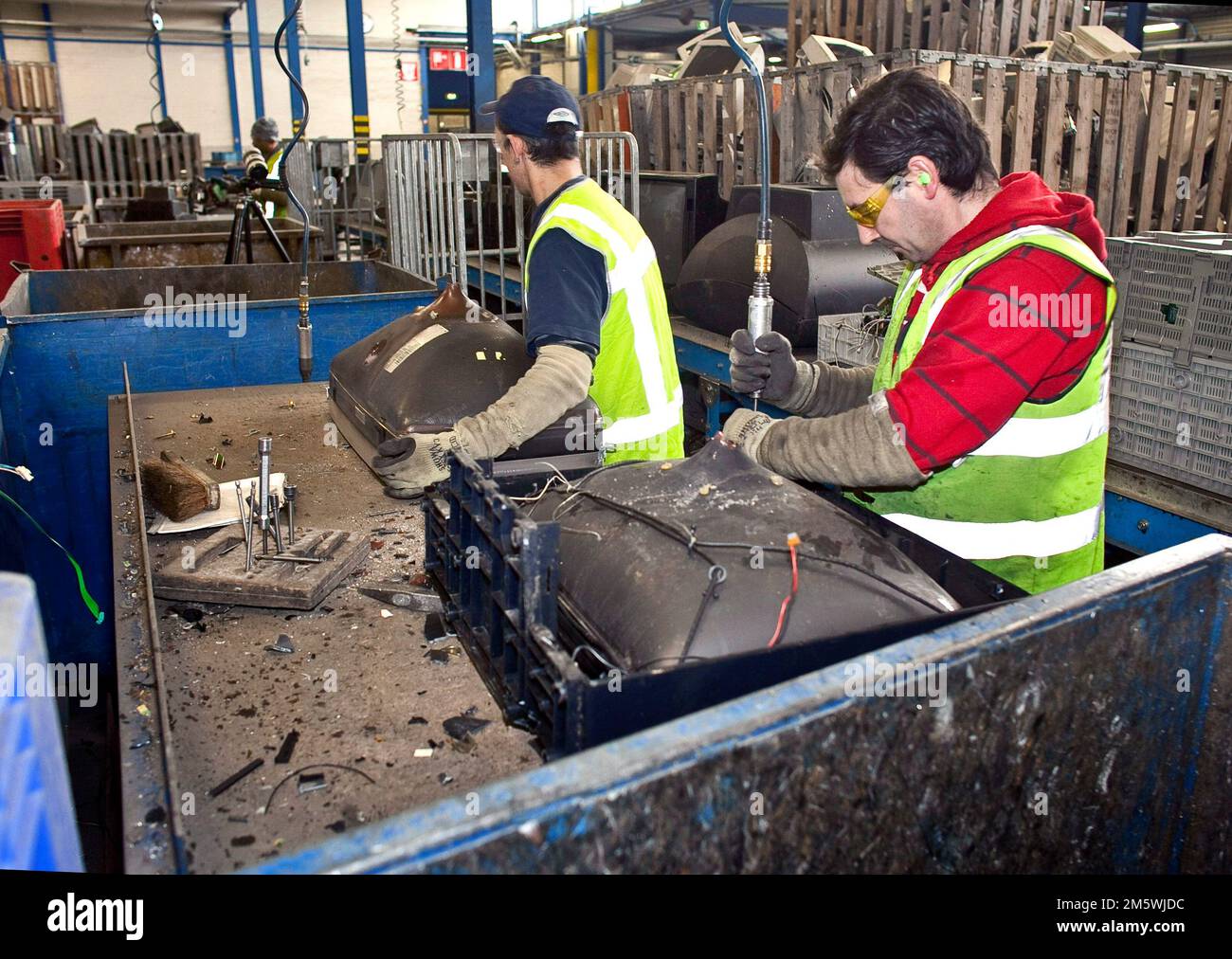 E-waste. Electronics recycling by sims, dismantling televisions ...