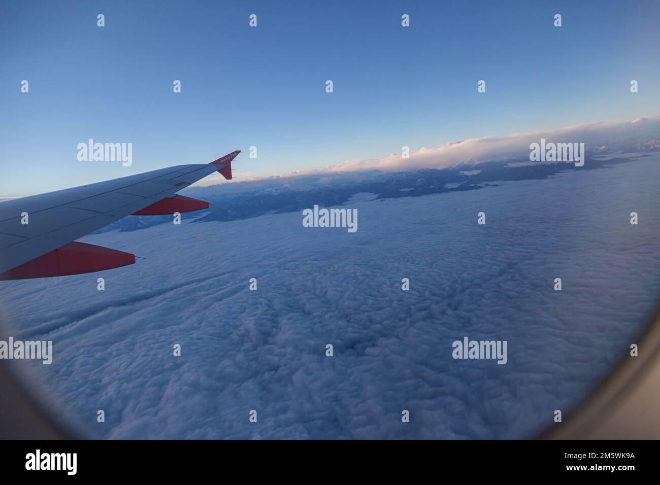 View from an EasyJet plane window. Wing with airline logo over clouds ...