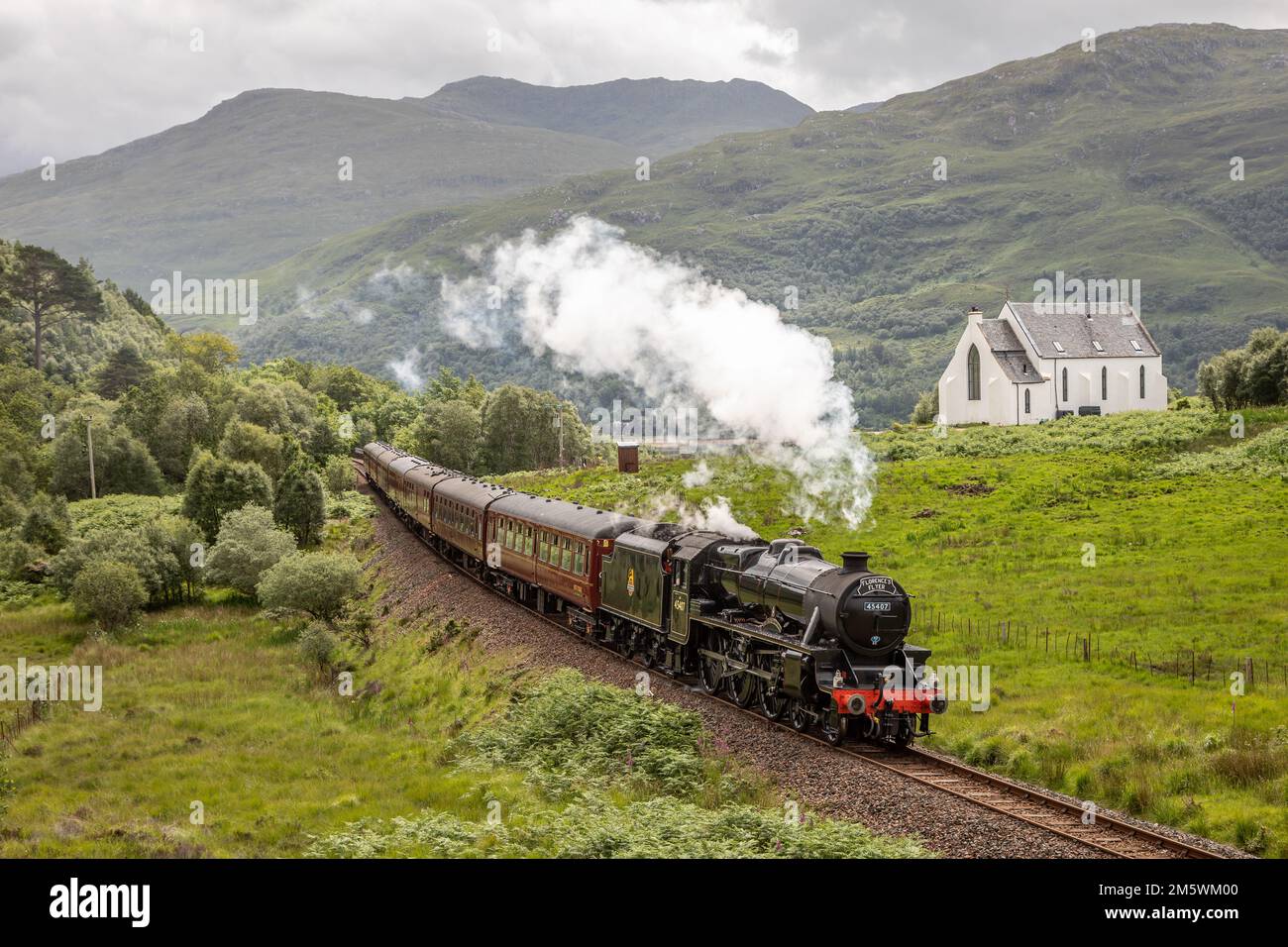BR 4-6-0 5MT No. 45407 'The Lancashire Fusilier' passes Our Lady of the ...