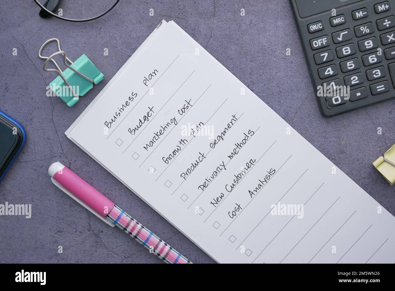 tick mark on business planning goals on notepad Stock Photo - Alamy