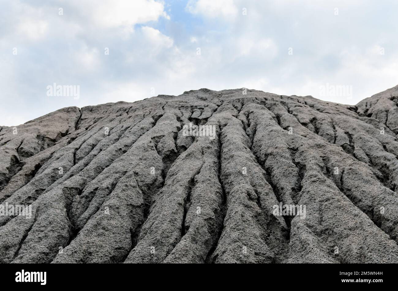 Heap Of Gravel With Water Stains From Rain On A Background Of Blue Sky heap-of-gravel-with-water-stains-from-rain-on-a-background-of-blue-sky