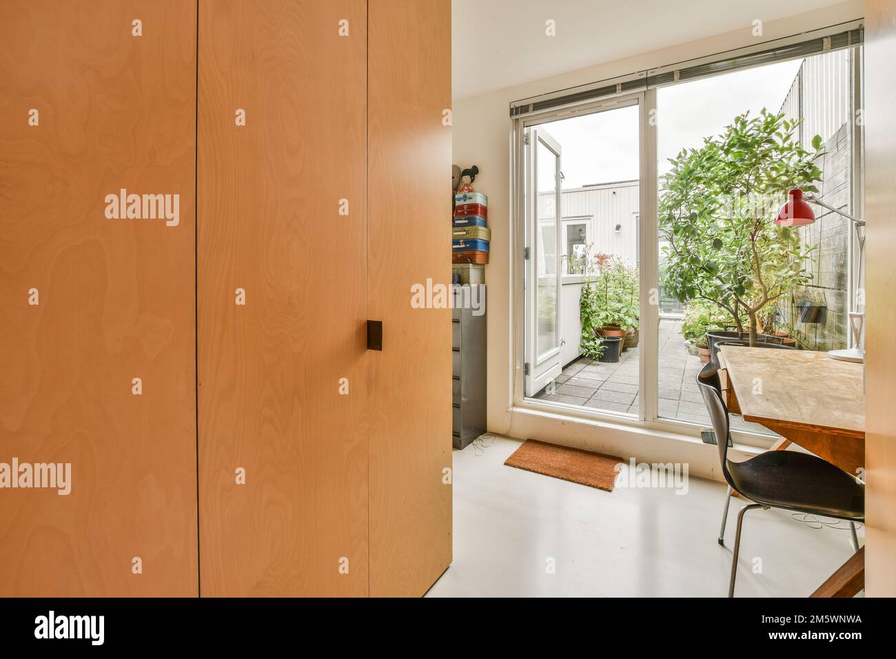 the inside of a house with wood paneled walls and sliding doors that ...