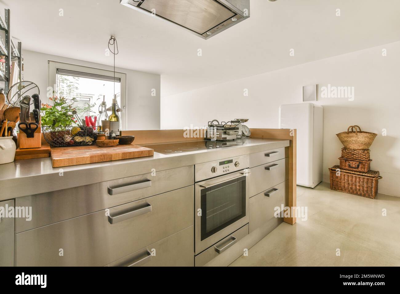 a modern kitchen with stainless steel appliances and wood counter tops ...