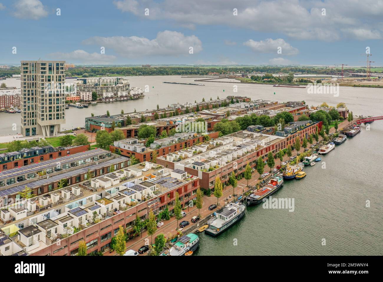 an aerial view of some buildings and boats on the water in front of a ...