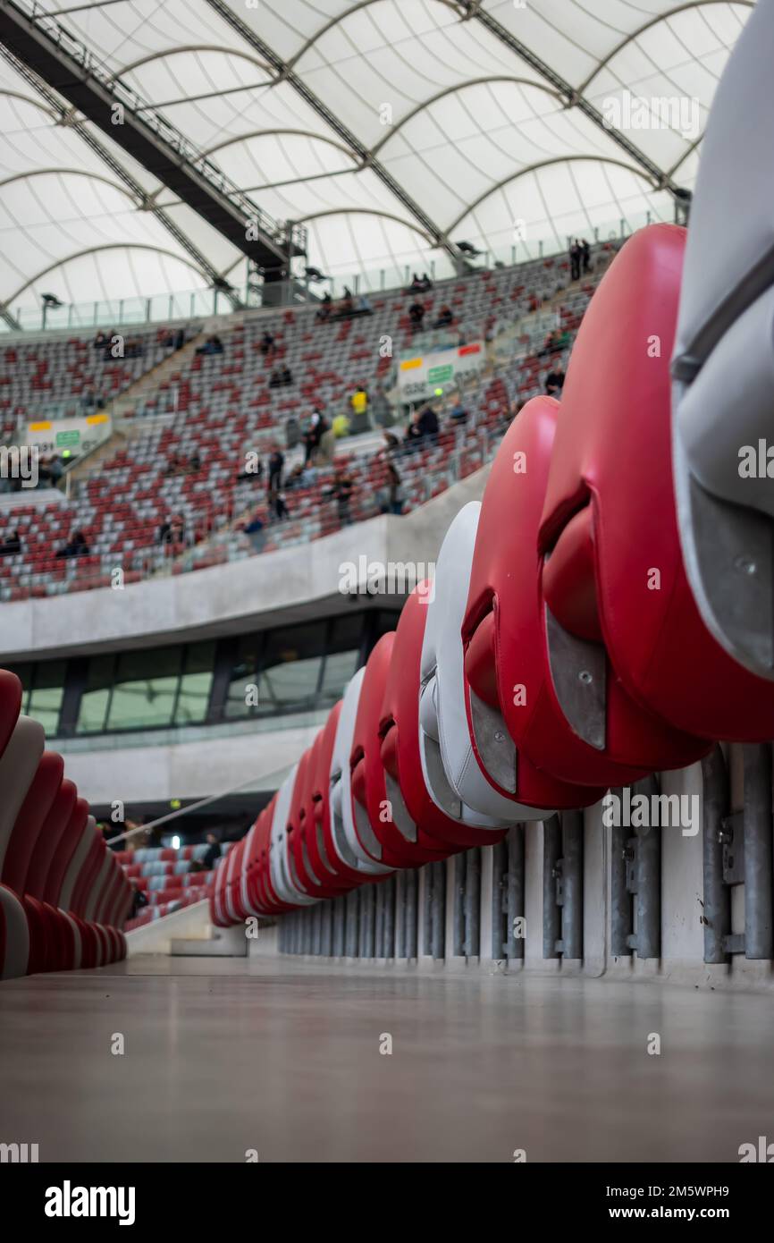 Rows of empty white and red chairs in a football stadium. Anticipation ...