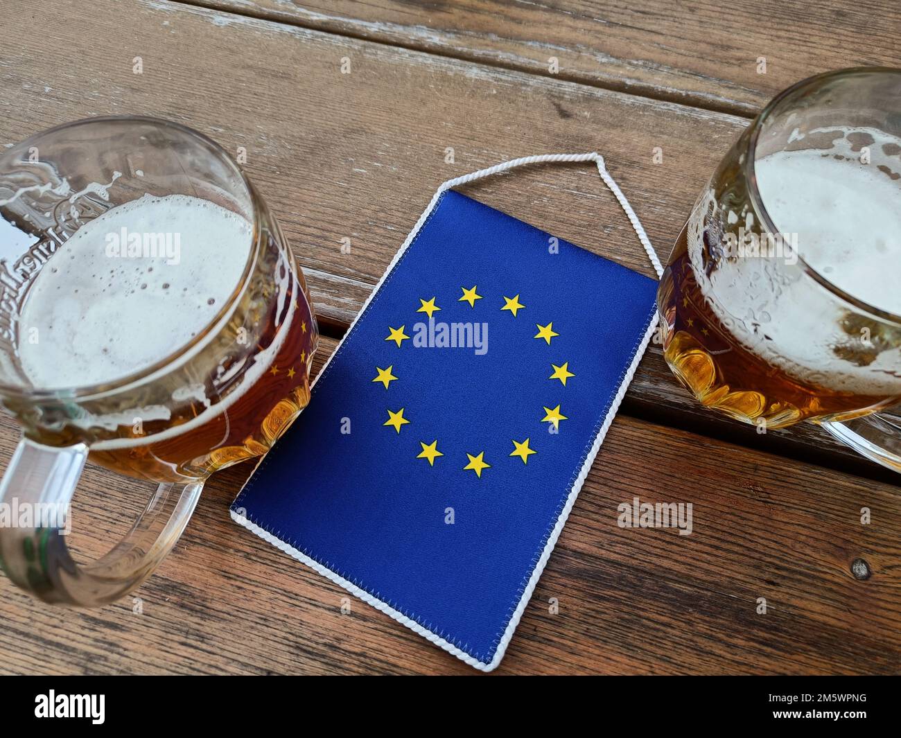 Two glasses of Czech beer (Pilsner Urquell) on a wooden table with a ...