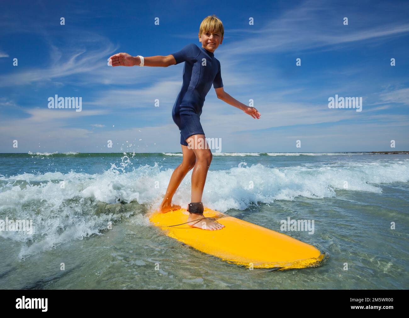 Boy standing on surfboard hi-res stock photography and images - Alamy